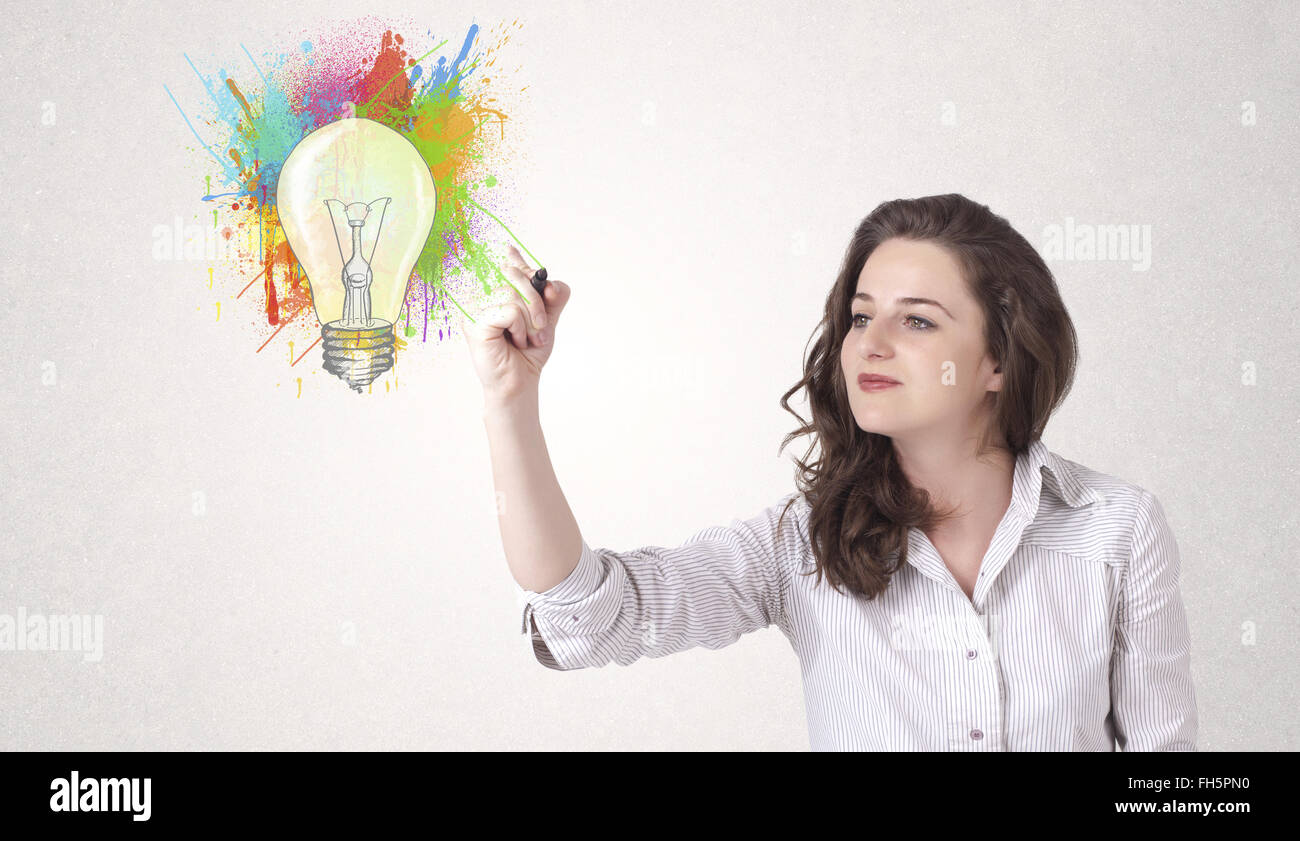 Young lady drawing a colorful light bulb with colorful splashes Stock ...