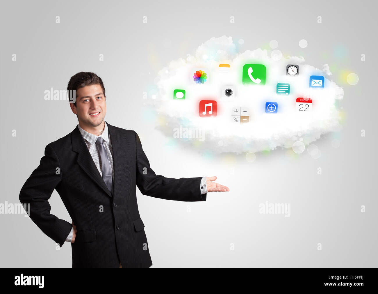 Young man presenting cloud with colorful app icons and symbols Stock ...