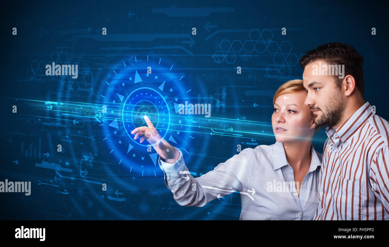 Young tech couple pressing high technology control panel screen concept ...