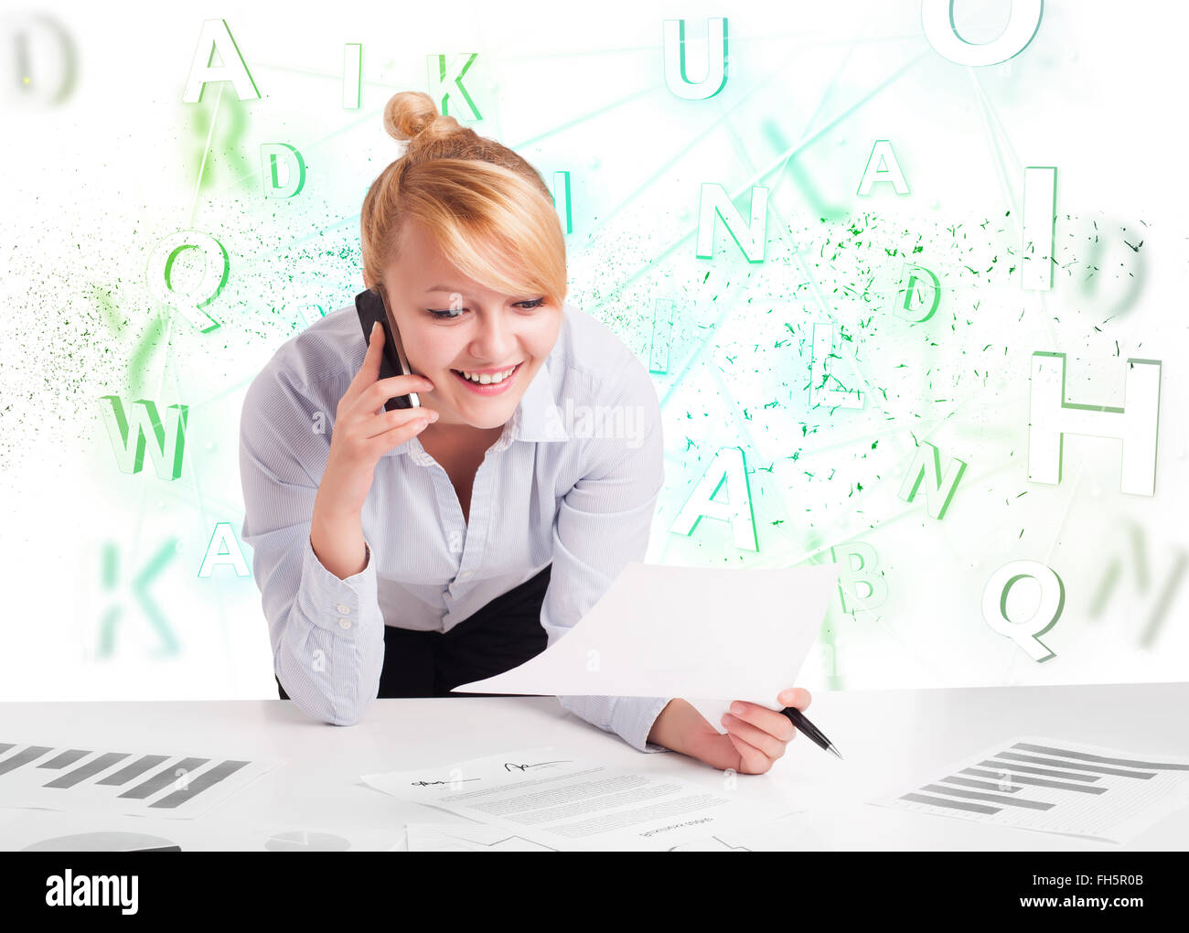 Business woman at desk with green word cloud Stock Photo - Alamy