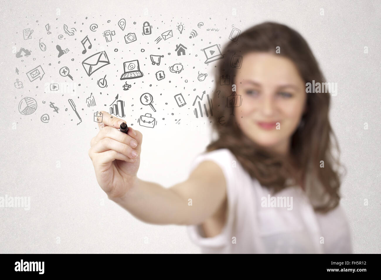 Young woman drawing and sketching icons and symbols Stock Photo - Alamy