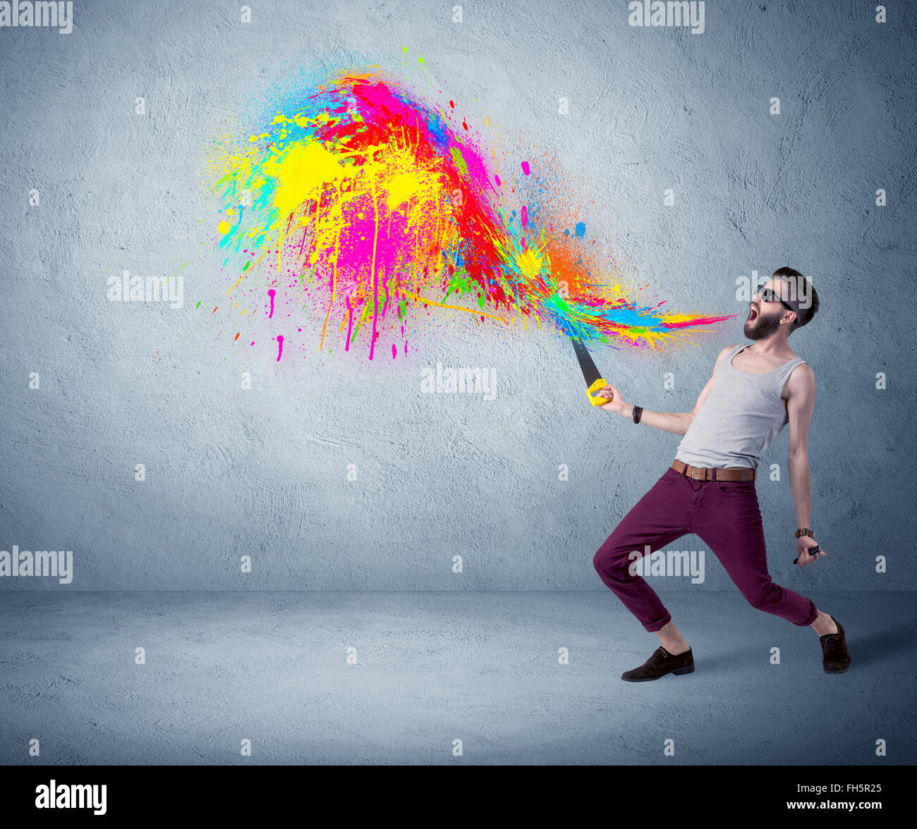 Hipster guy shouting colorful paint on wall Stock Photo - Alamy