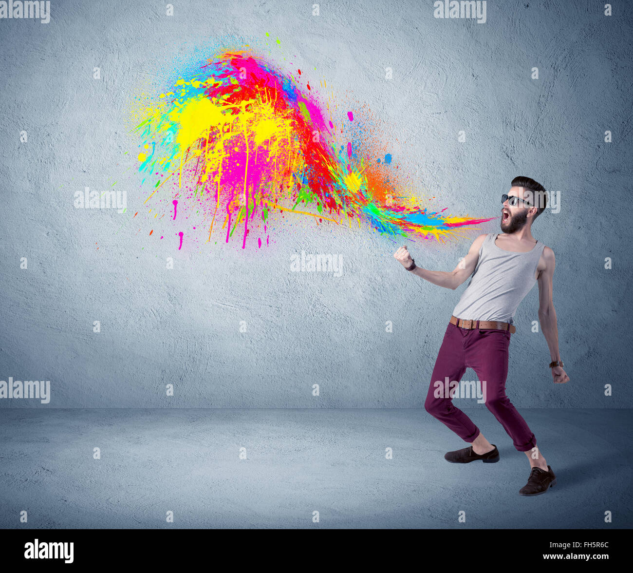 Hipster guy shouting colorful paint on wall Stock Photo - Alamy
