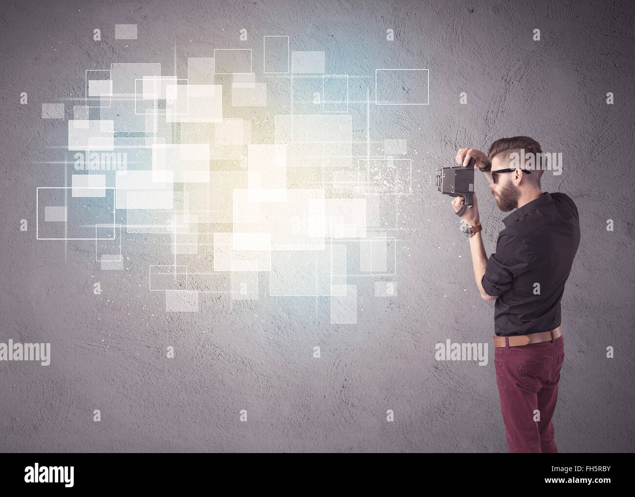 Hipster guy with retro camera in action Stock Photo - Alamy