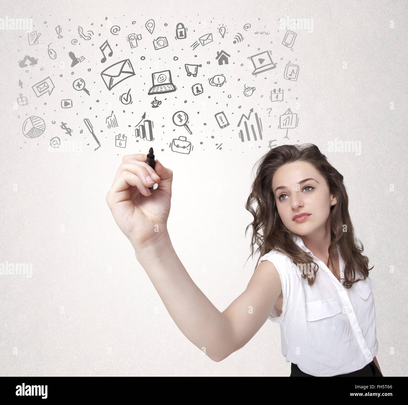 Young woman drawing and sketching icons and symbols Stock Photo - Alamy