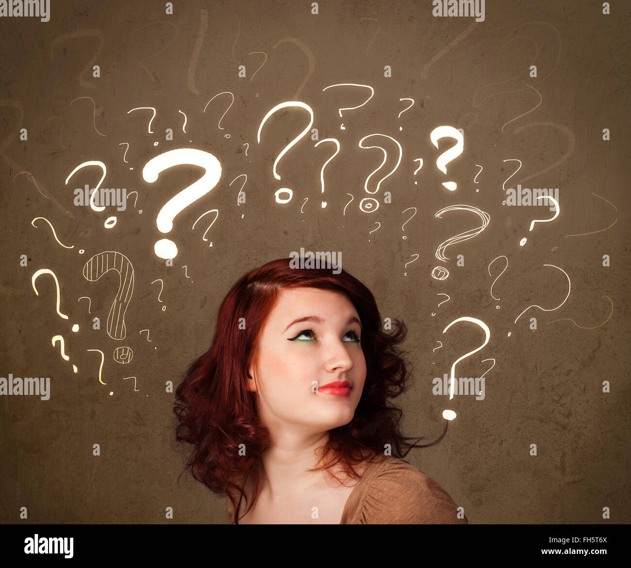 girl with question mark symbols around her head Stock Photo - Alamy