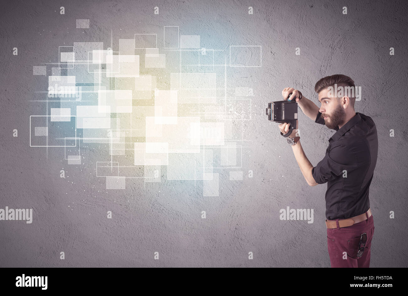 Hipster guy with retro camera in action Stock Photo - Alamy