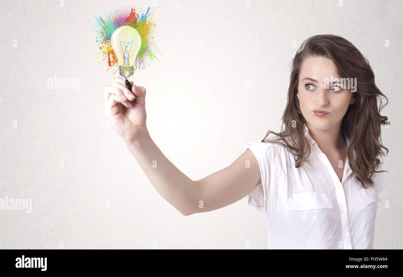 Young lady drawing a colorful light bulb with colorful splashes Stock ...