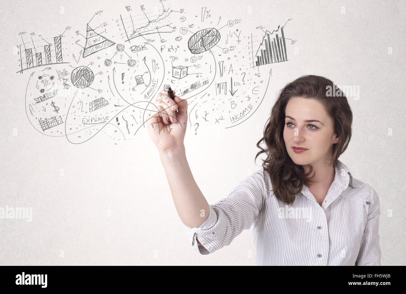 Pretty girl sketching graphs and diagrams on wall Stock Photo - Alamy