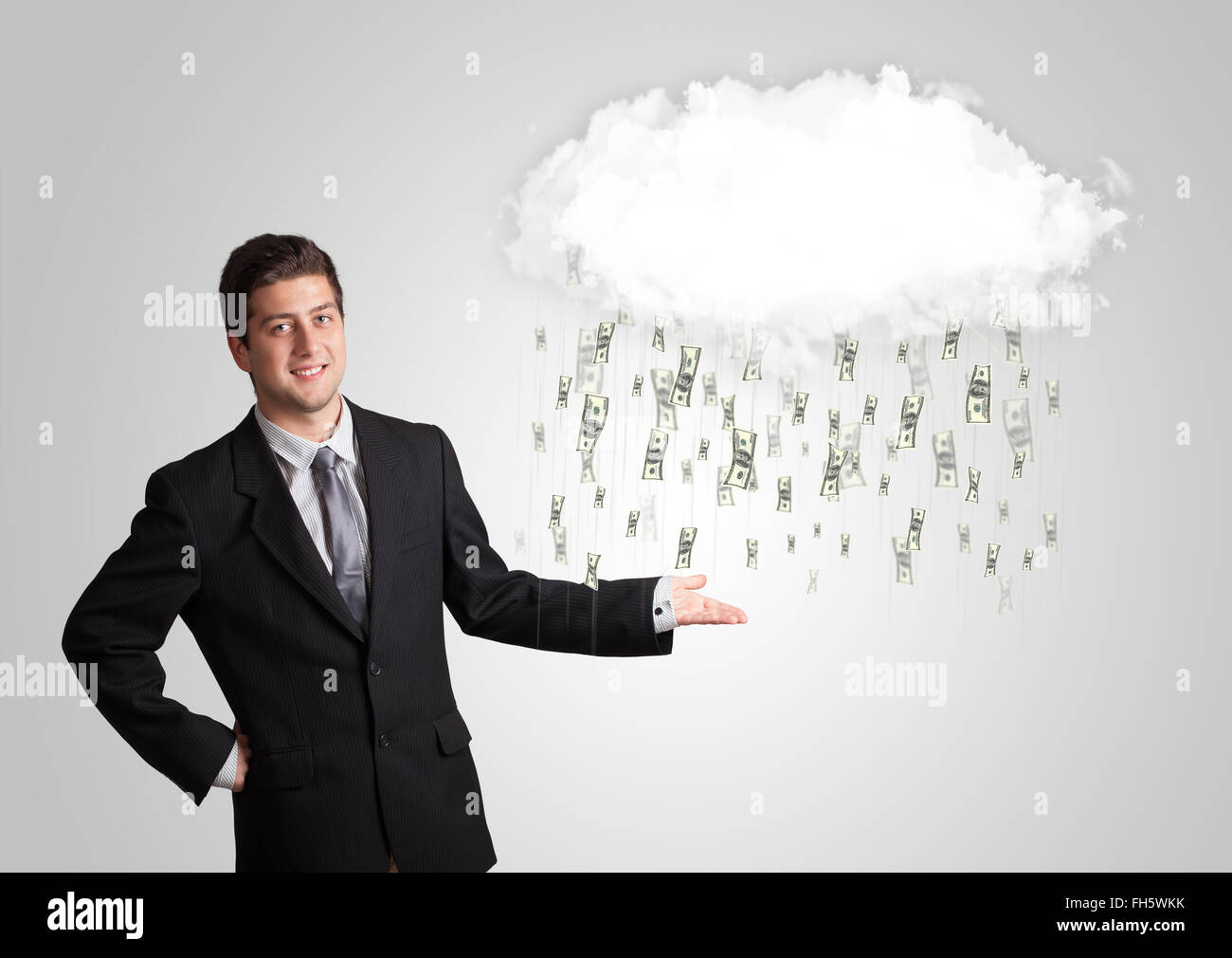 Man with cloud and money rain concept Stock Photo - Alamy