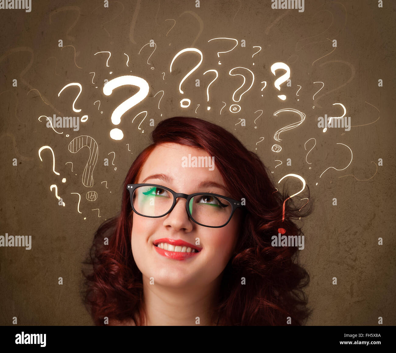 girl with question mark symbols around her head Stock Photo - Alamy