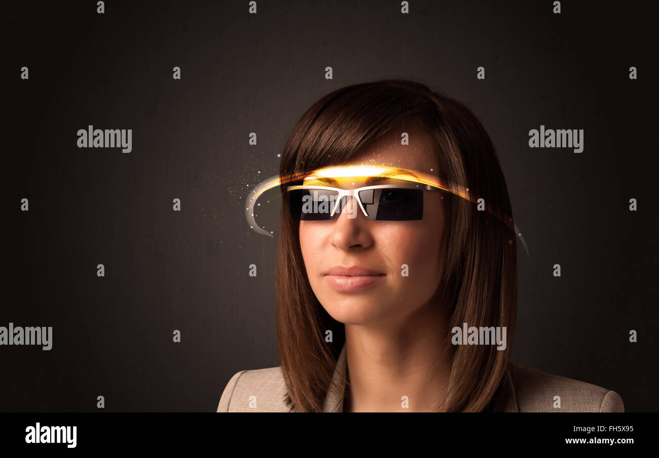 Pretty woman looking with futuristic high tech glasses Stock Photo - Alamy
