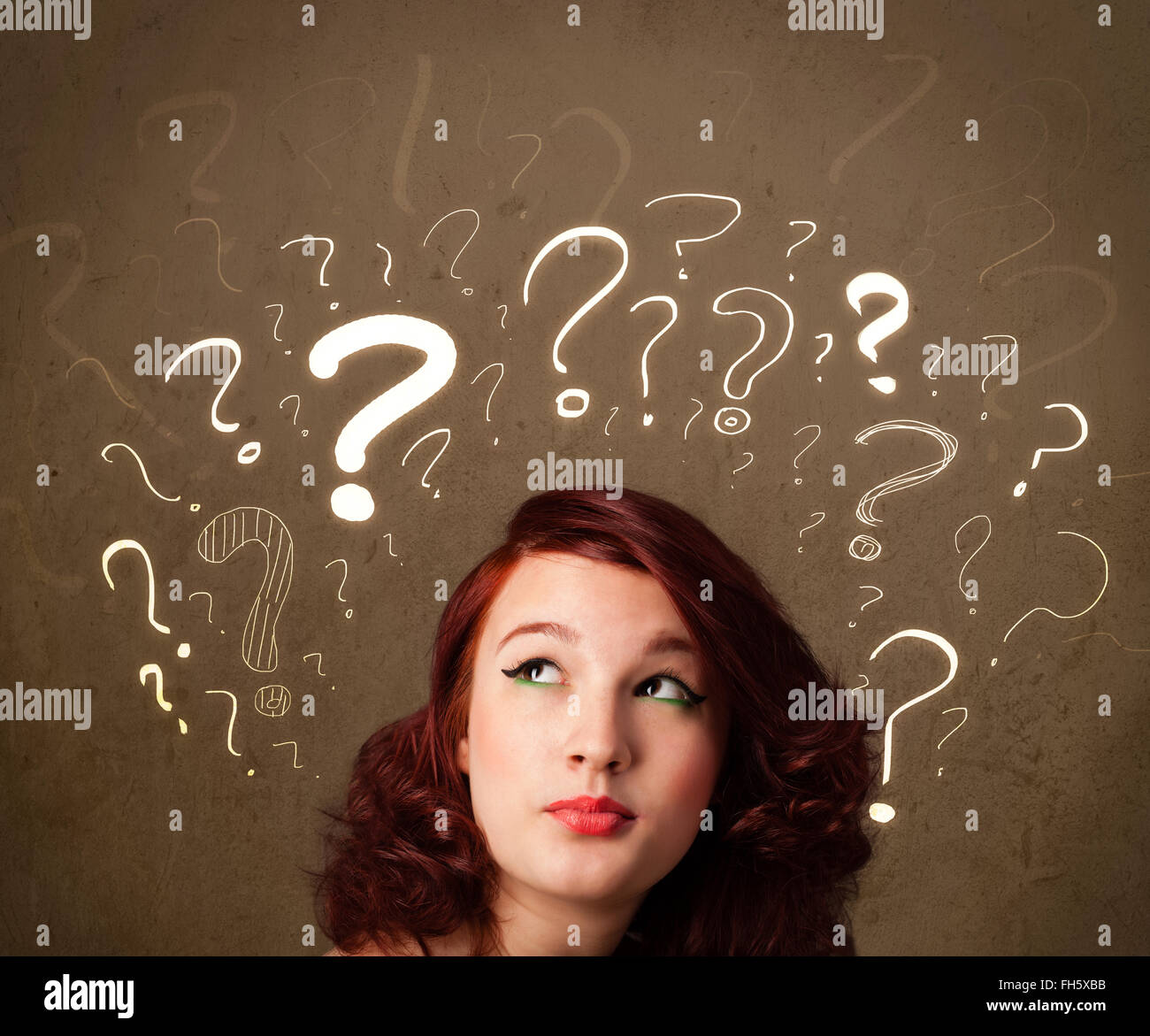 girl with question mark symbols around her head Stock Photo - Alamy