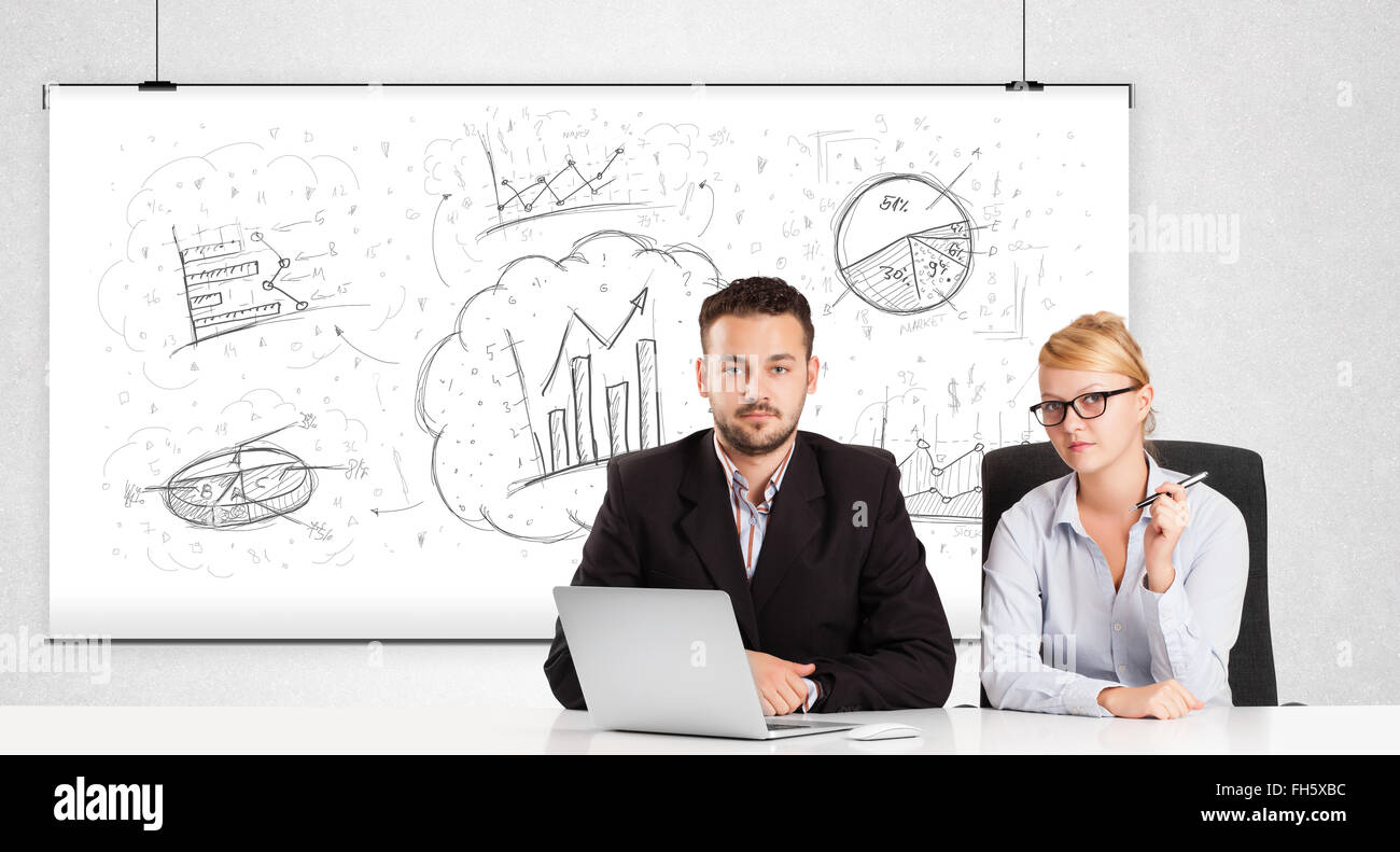 Business man and woman sitting at table with hand drawn graph charts ...