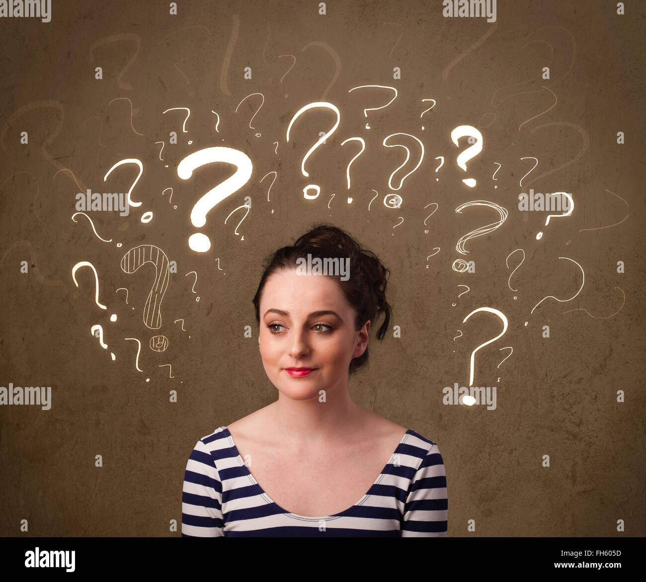 girl with question mark symbols around her head Stock Photo - Alamy