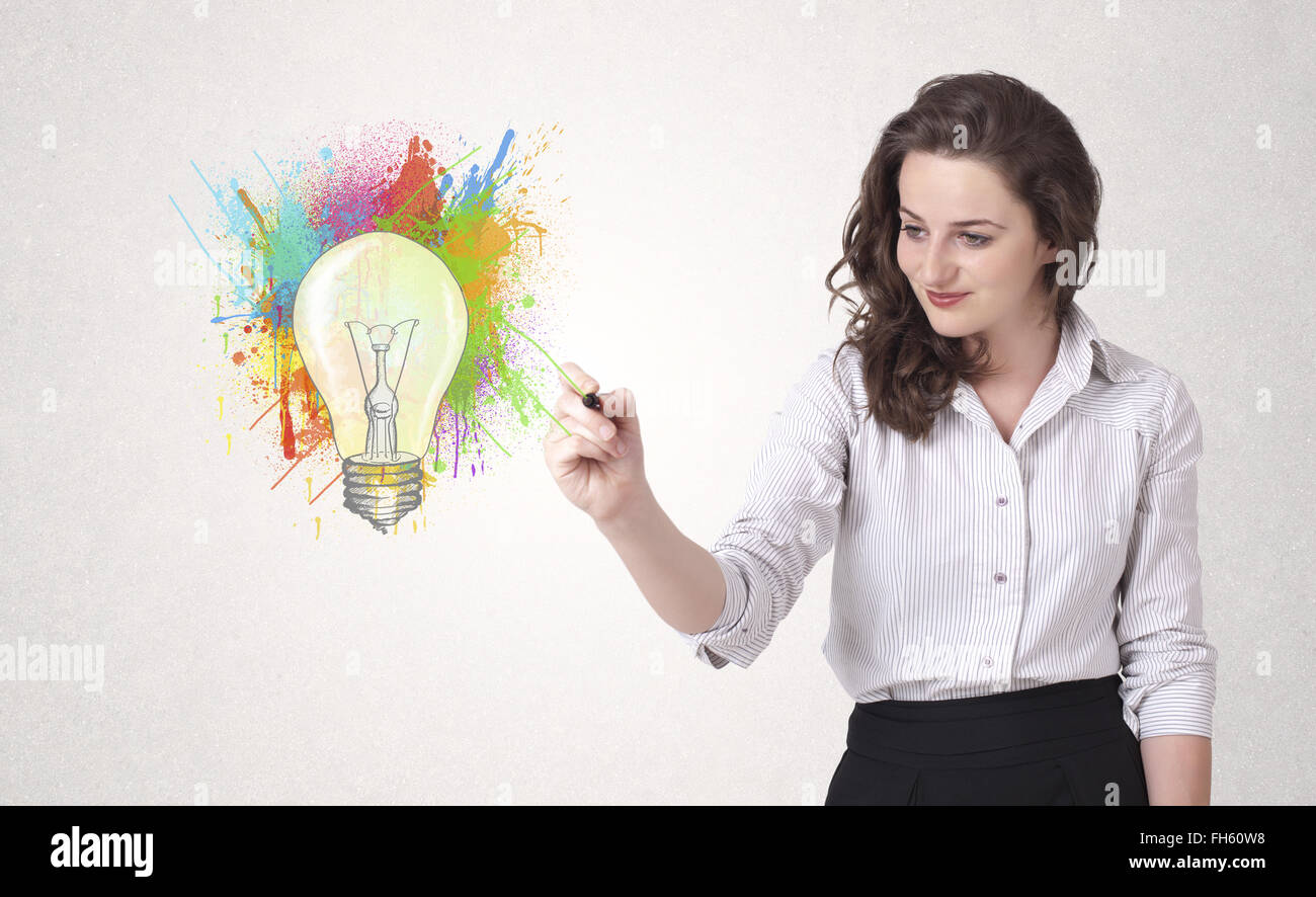 Young lady drawing a colorful light bulb with colorful splashes Stock ...