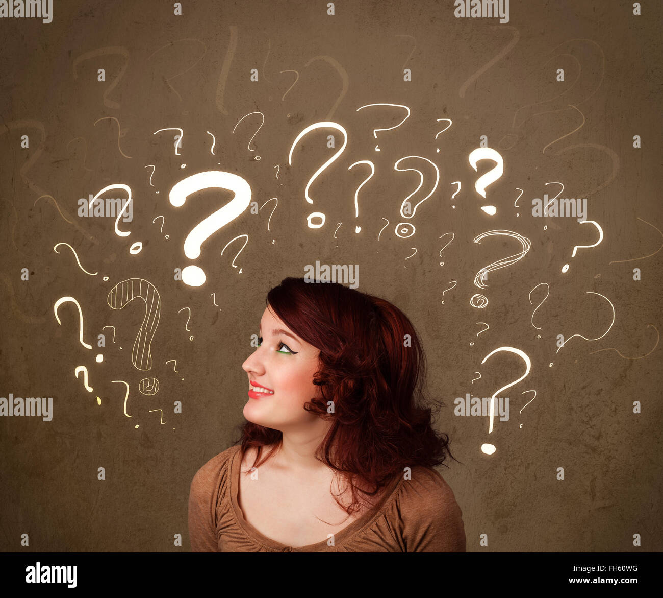 girl with question mark symbols around her head Stock Photo - Alamy