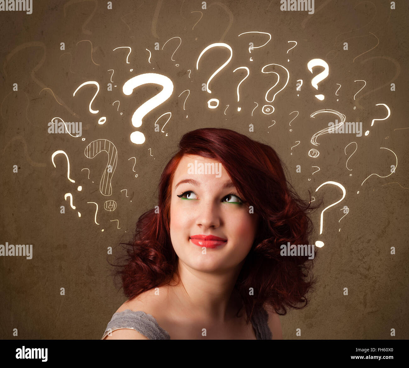 girl with question mark symbols around her head Stock Photo - Alamy