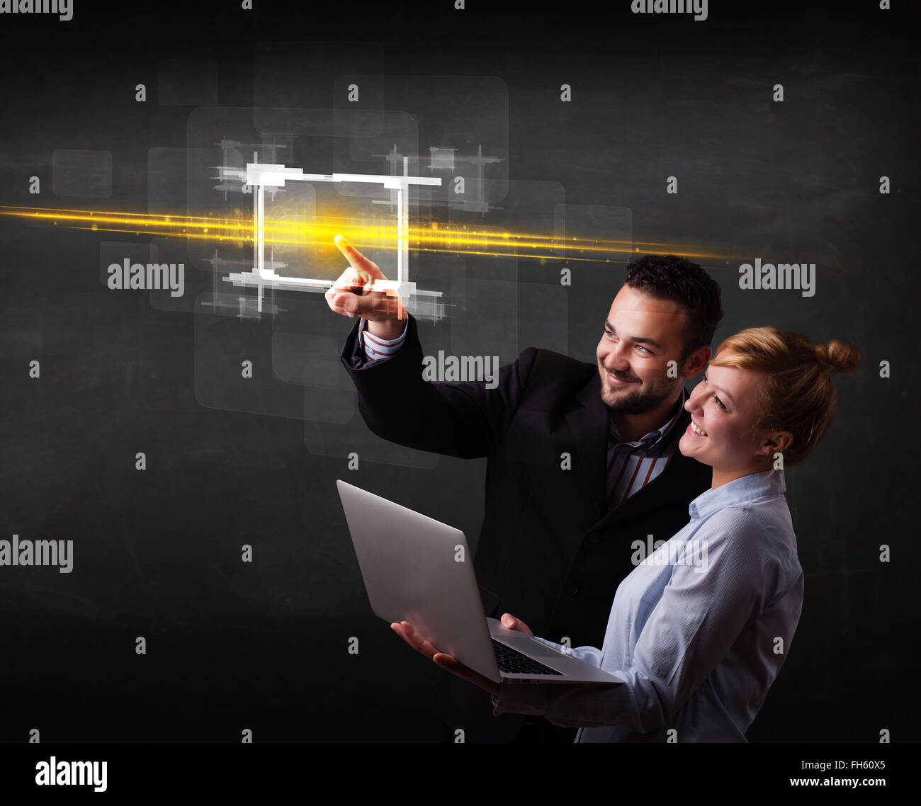 Young tech business couple touching button with orange light beams ...