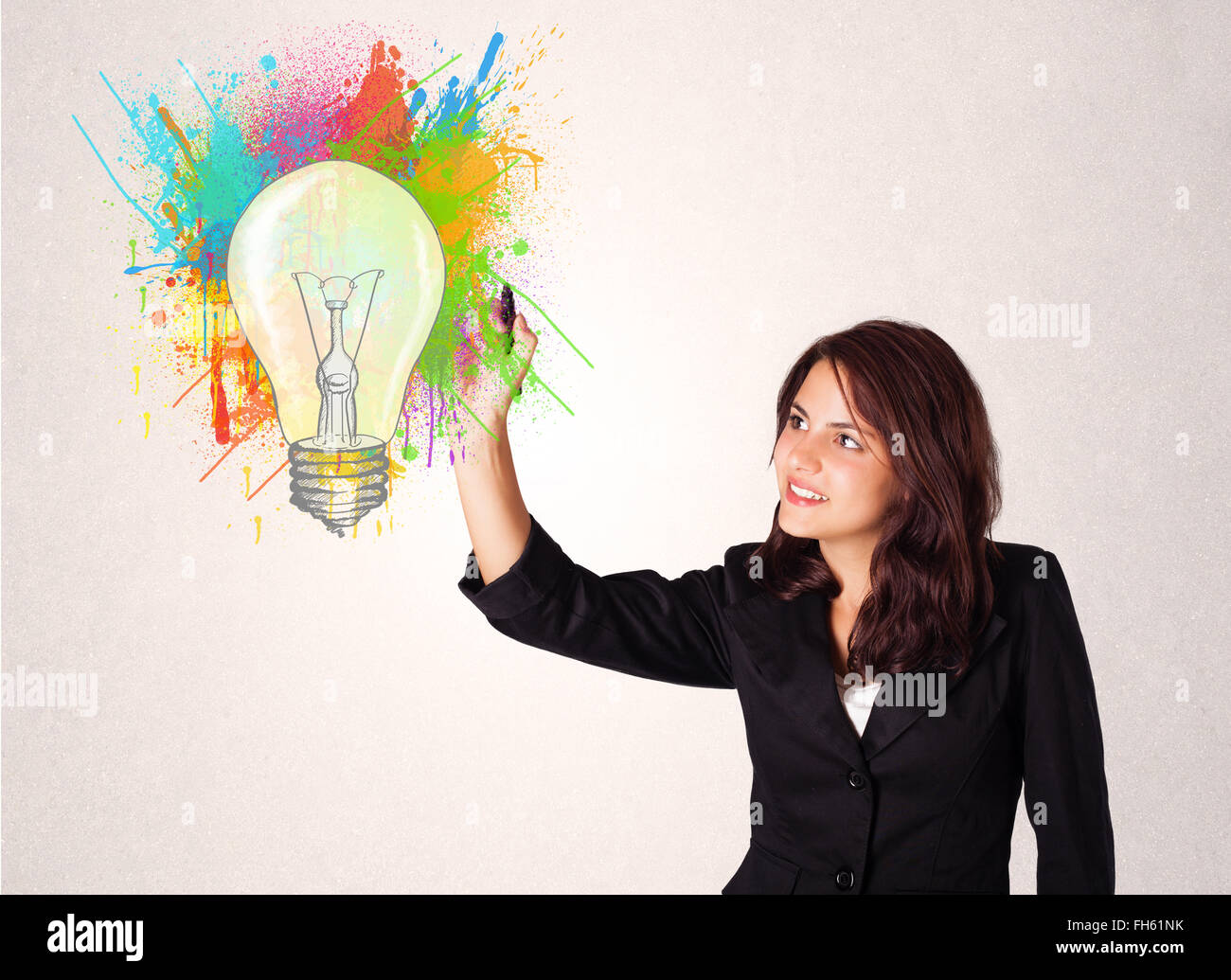 Young lady drawing a colorful light bulb with colorful splashes Stock ...