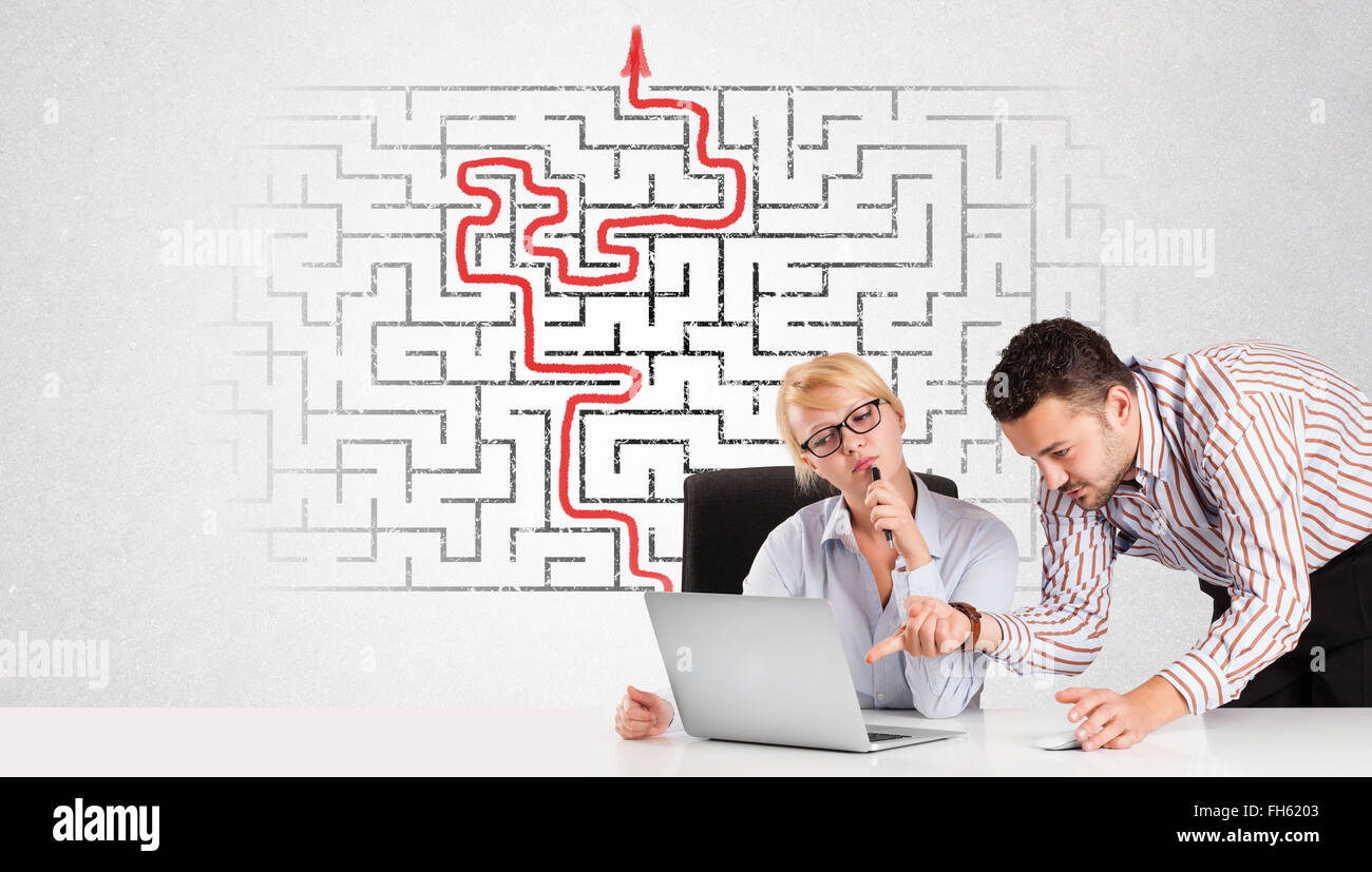 Business persons at desk with labyrinth and arrow Stock Photo - Alamy