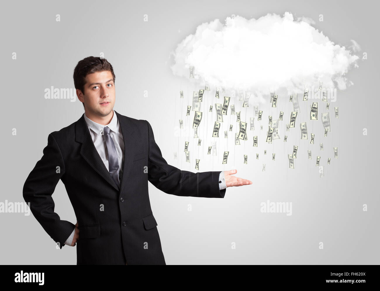 Man with cloud and money rain concept Stock Photo - Alamy