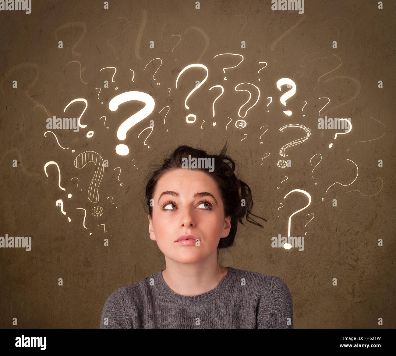 girl with question mark symbols around her head Stock Photo - Alamy