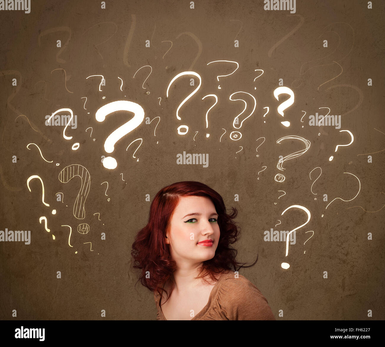 girl with question mark symbols around her head Stock Photo - Alamy