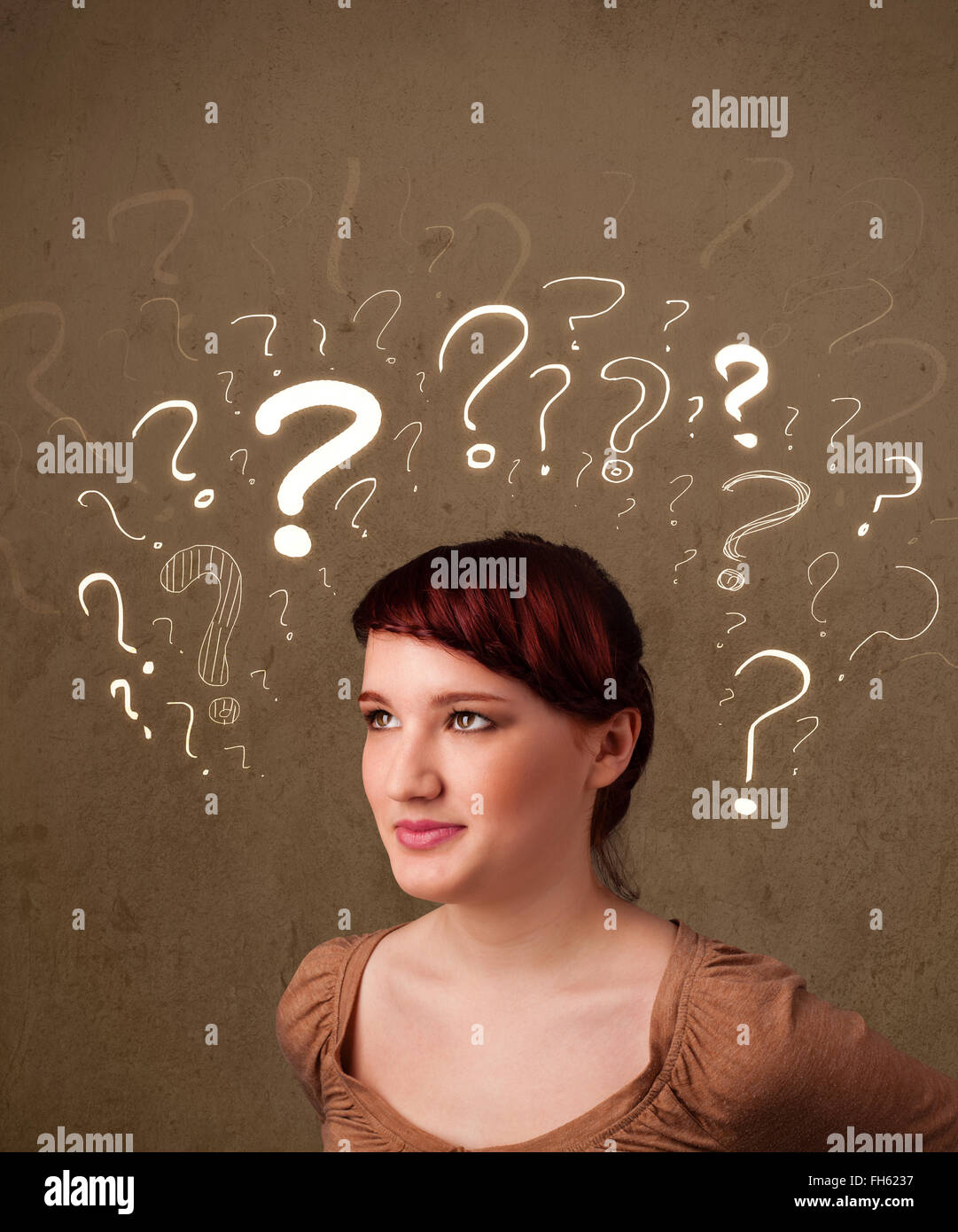 girl with question mark symbols around her head Stock Photo - Alamy