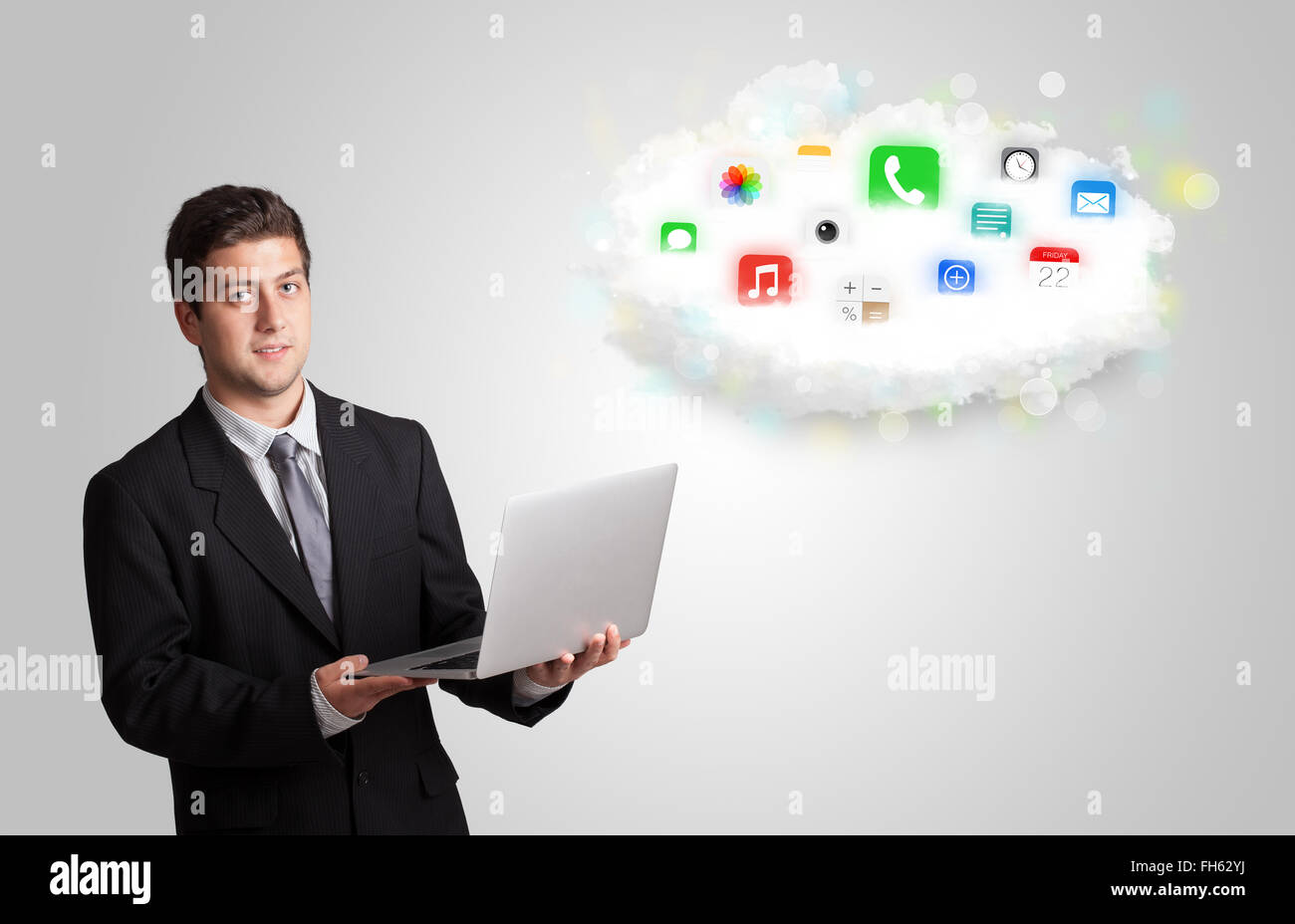 Young man presenting cloud with colorful app icons and symbols Stock ...