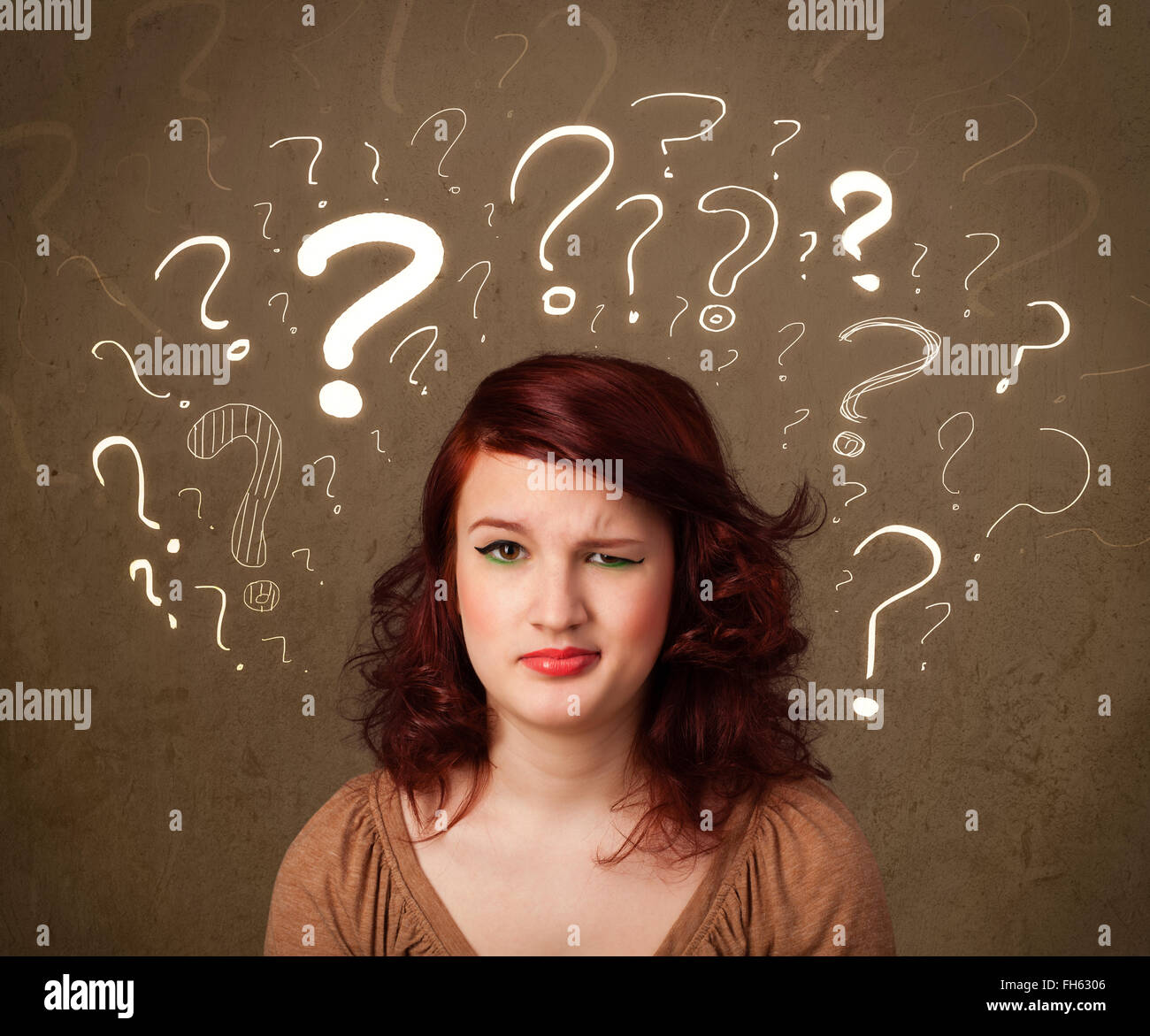 girl with question mark symbols around her head Stock Photo - Alamy