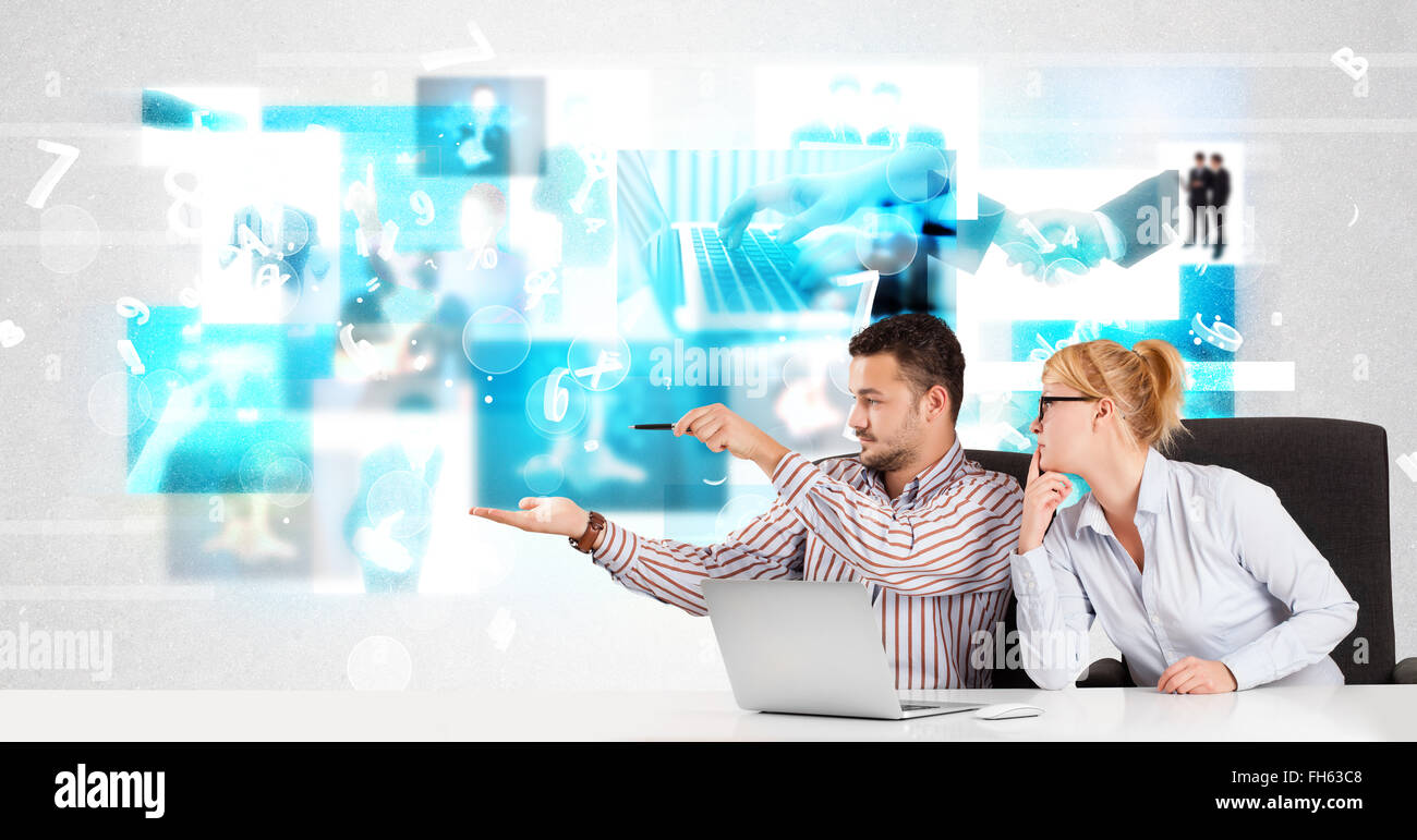 Business persons at desk with modern tech images at background Stock ...