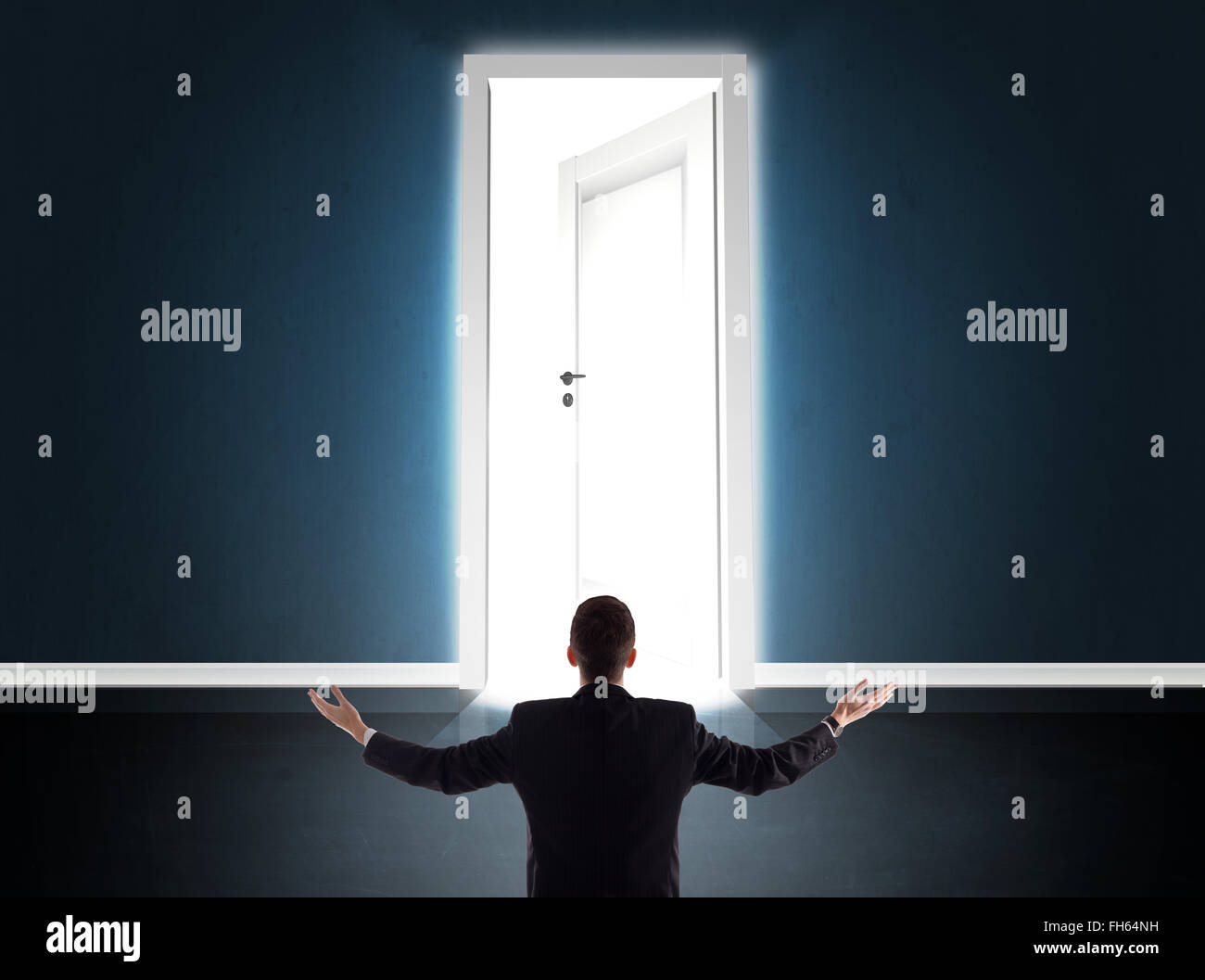 Business man looking at big bright opened door Stock Photo - Alamy
