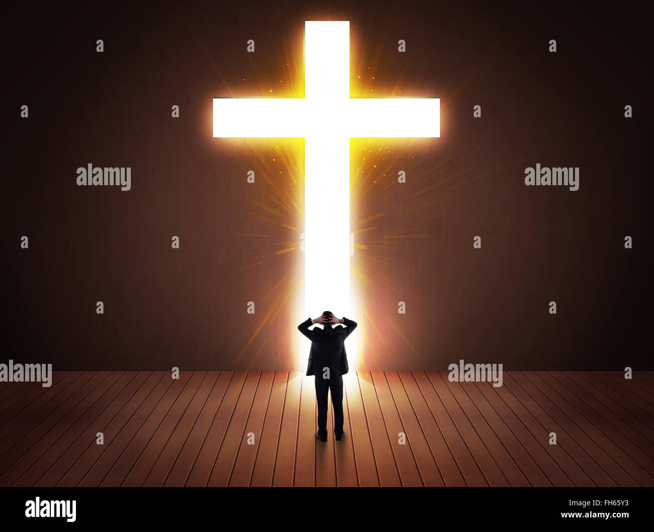 Man looking at bright cross sign Stock Photo - Alamy