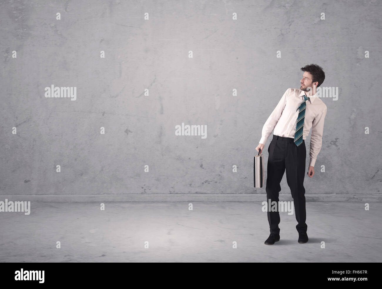 Young businessman standing confused Stock Photo - Alamy