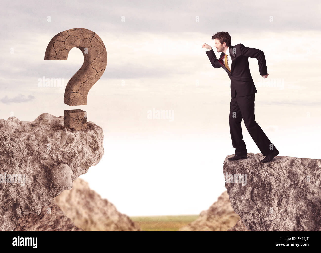 Businessman on rock mountain with a question mark Stock Photo - Alamy