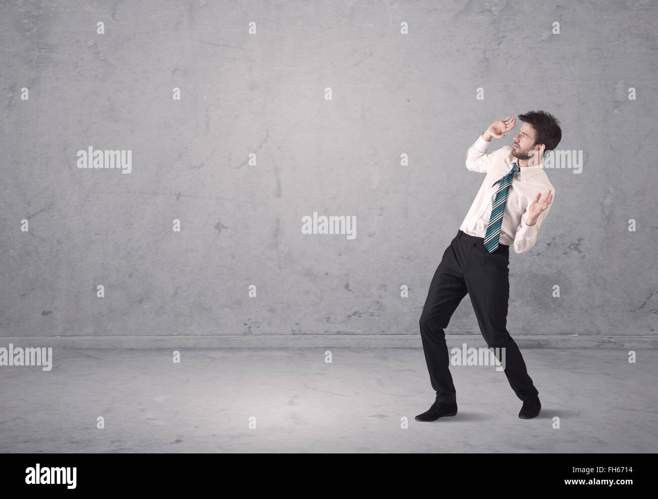 Young businessman standing confused Stock Photo - Alamy