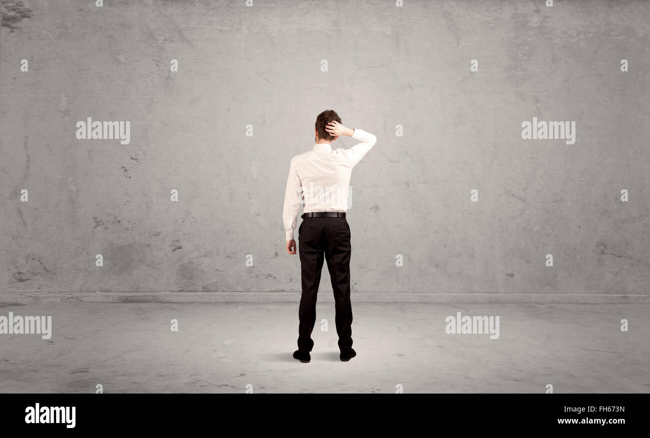 Businessman lost in empty urban space Stock Photo - Alamy
