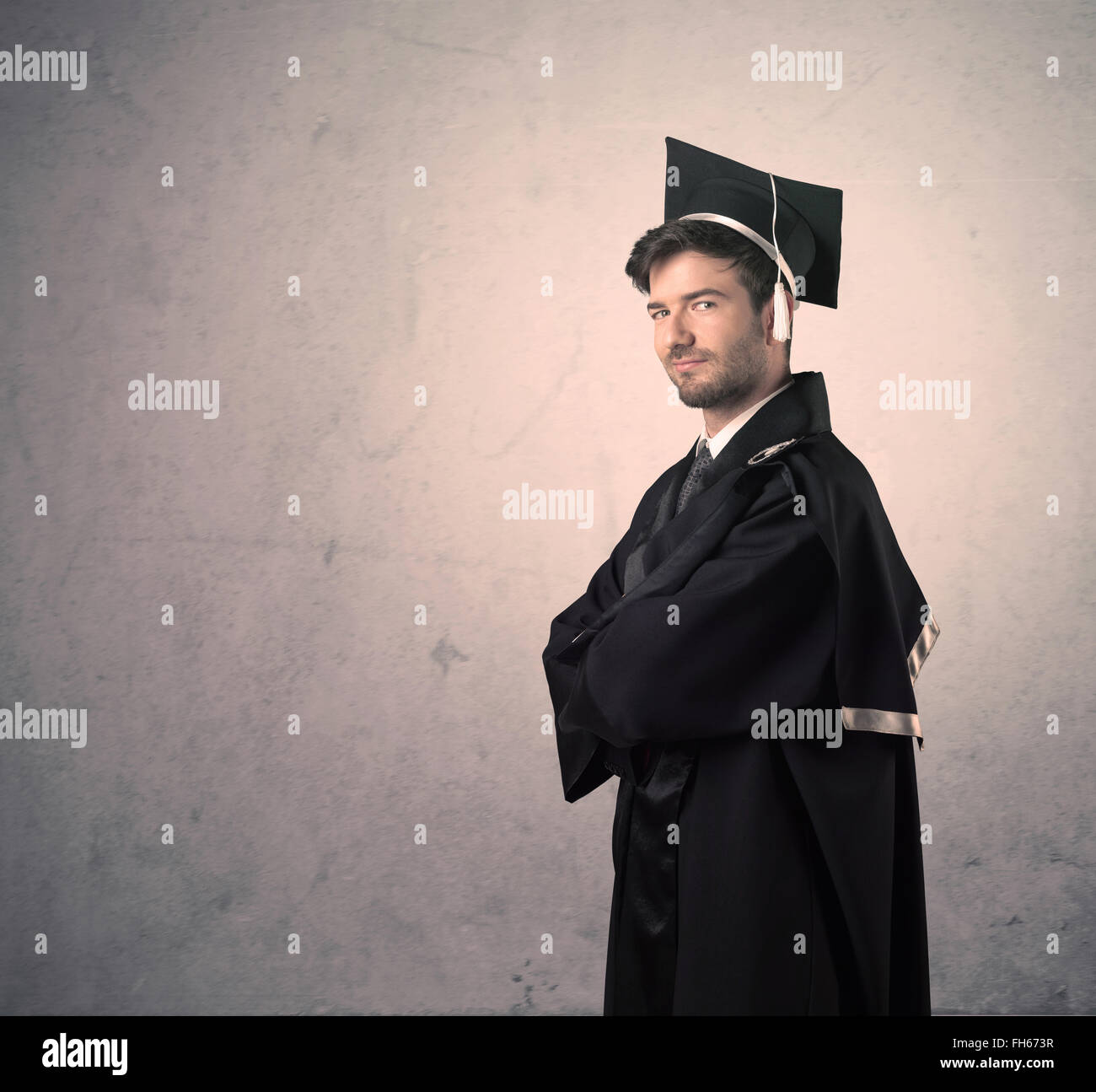 Portrait of a young graduate student on grungy background Stock Photo ...