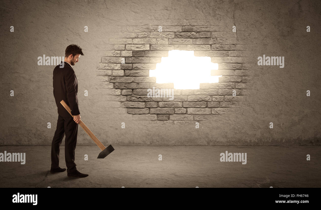 Business man hitting brick wall with hammer and opening a hole Stock ...