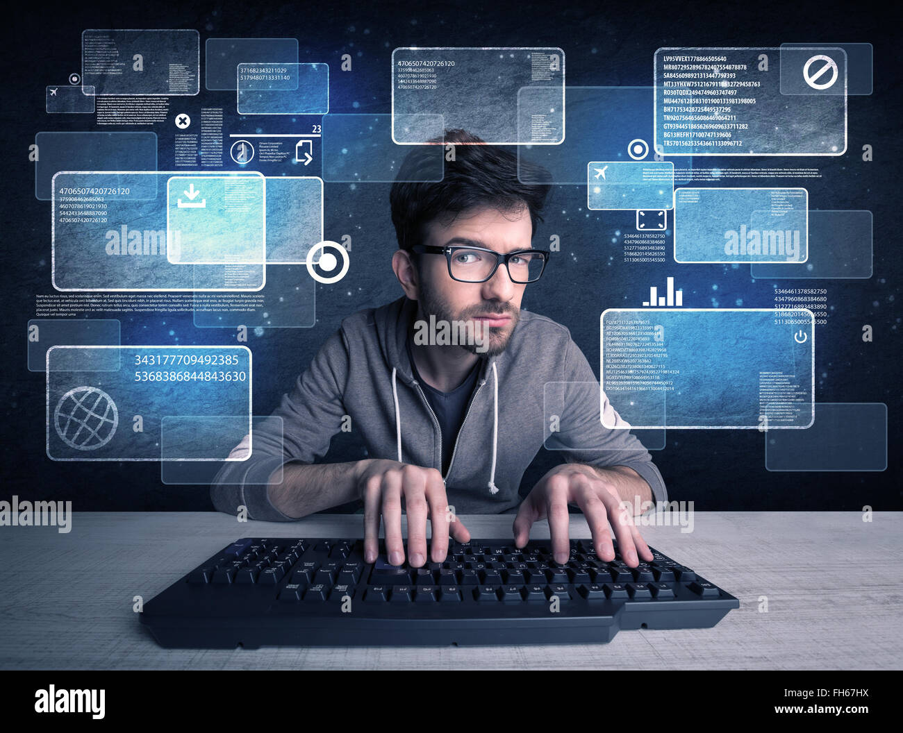 Nerd with glasses hacking websites Stock Photo - Alamy
