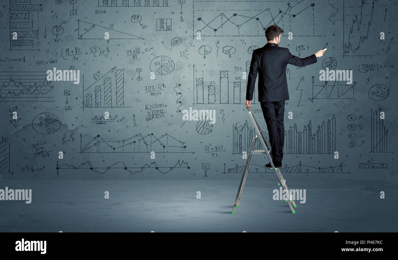 Man on ladder drawing charts Stock Photo - Alamy