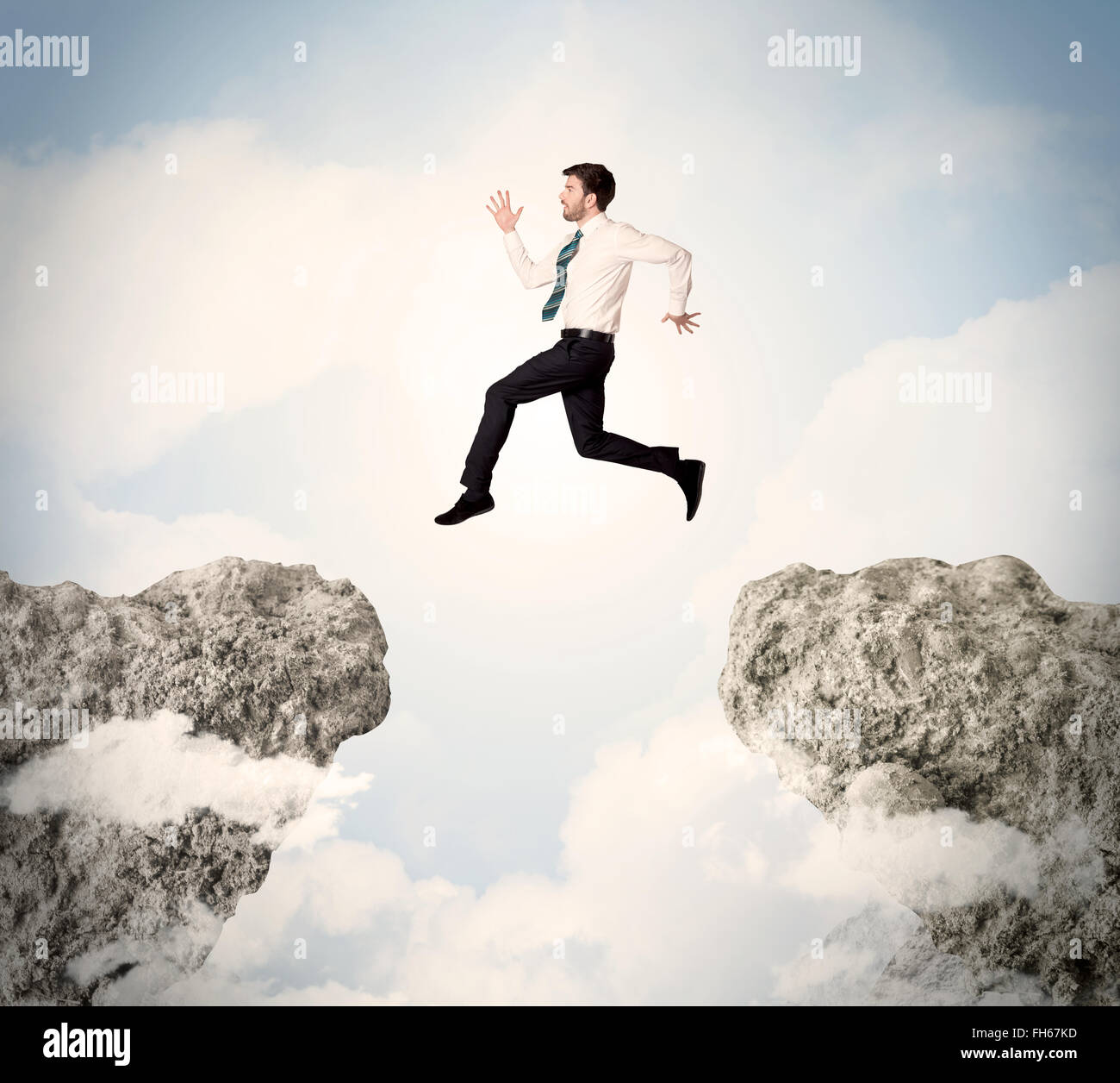 Business man jump dangerous mountain hi-res stock photography and ...