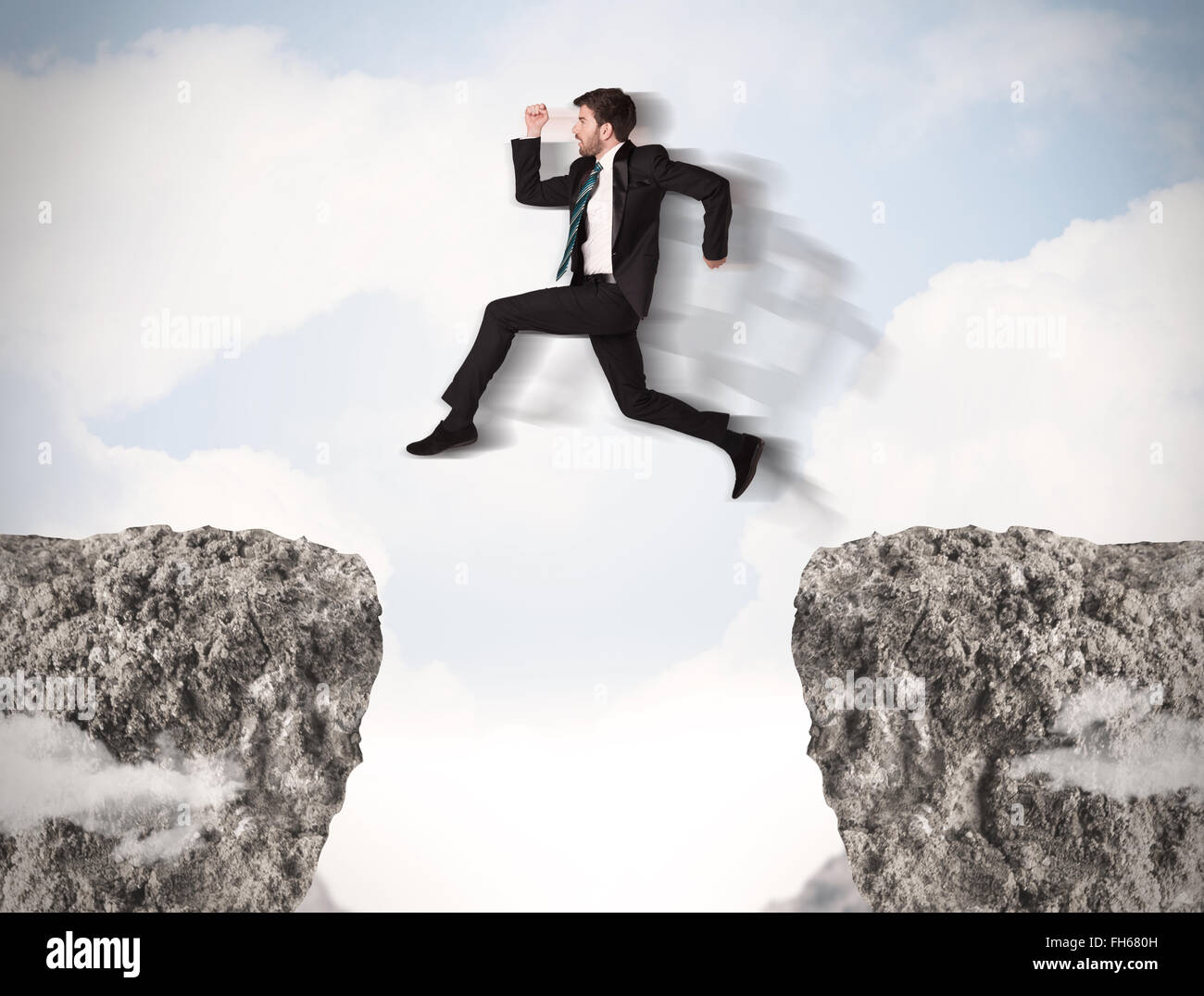 Funny business man jumping over rocks with gap Stock Photo - Alamy