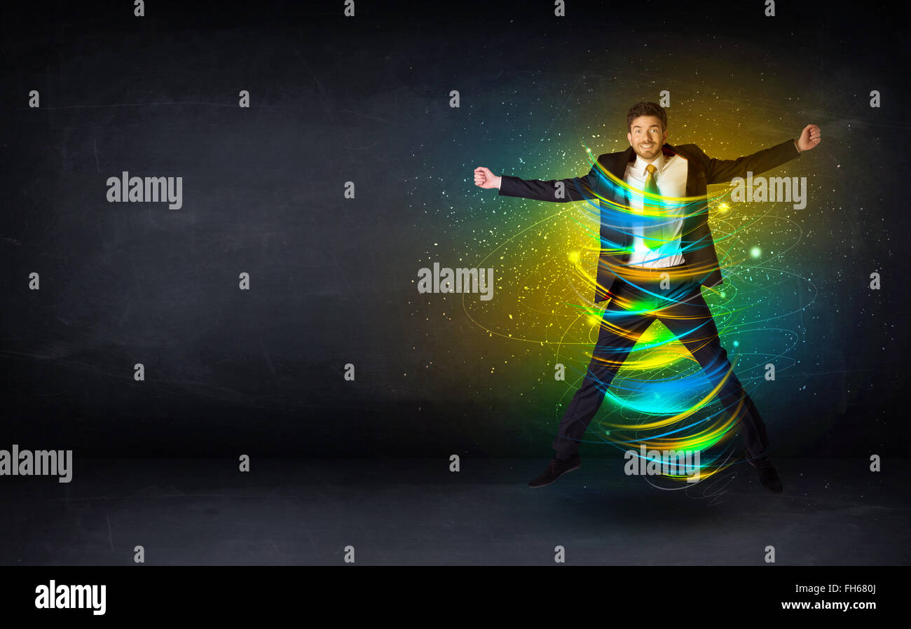 Excited business man jumping with energy colourful lines Stock Photo ...
