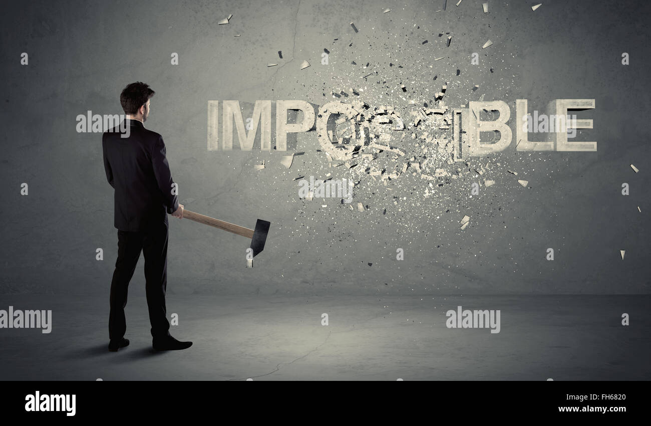 Business man hitting impossible sign with hammer Stock Photo - Alamy