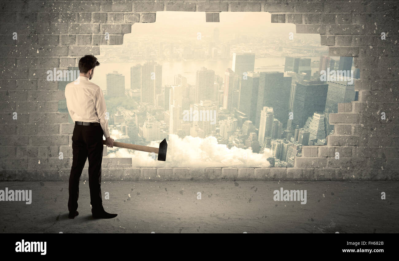 Business man hitting wall with hammer on city view Stock Photo - Alamy
