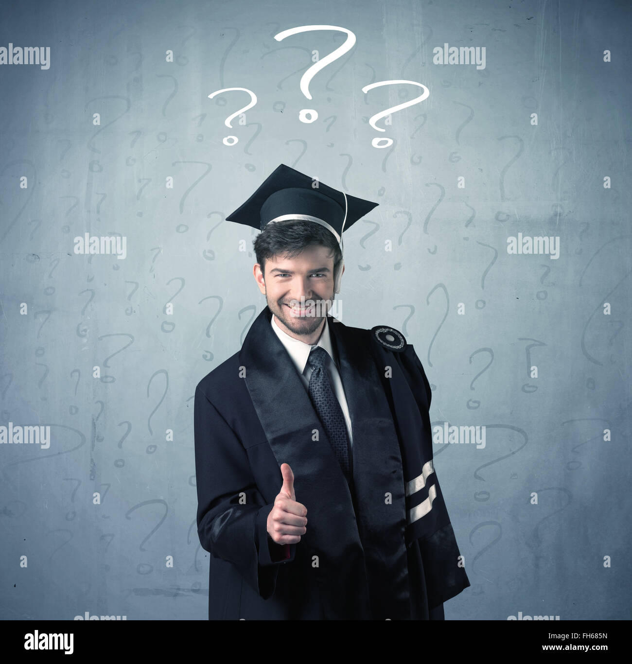 Young graduate teenager with question marks drawn Stock Photo - Alamy