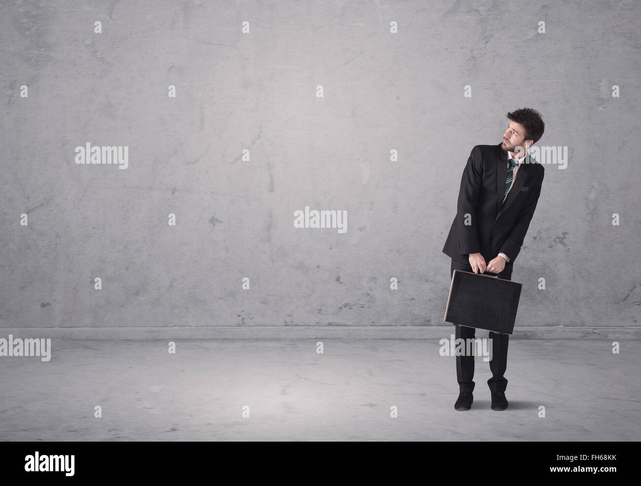 Young businessman standing confused Stock Photo - Alamy