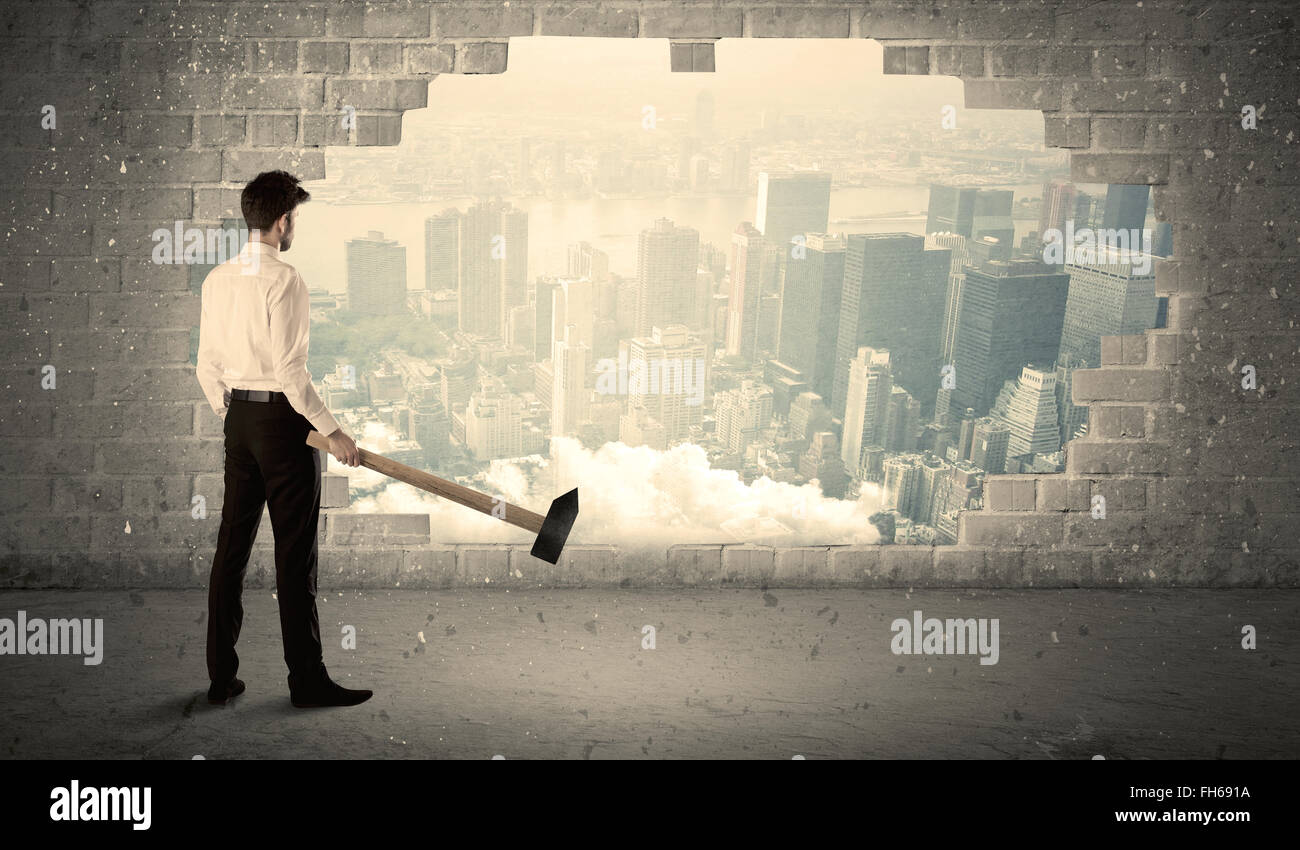 Business man hitting wall with hammer on city view Stock Photo - Alamy